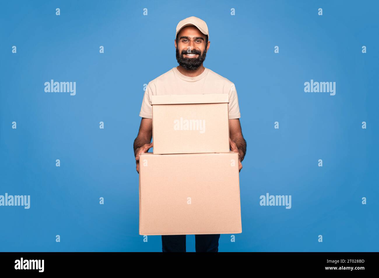 Express delivery concept. Happy indian courier man holding cardboard ...