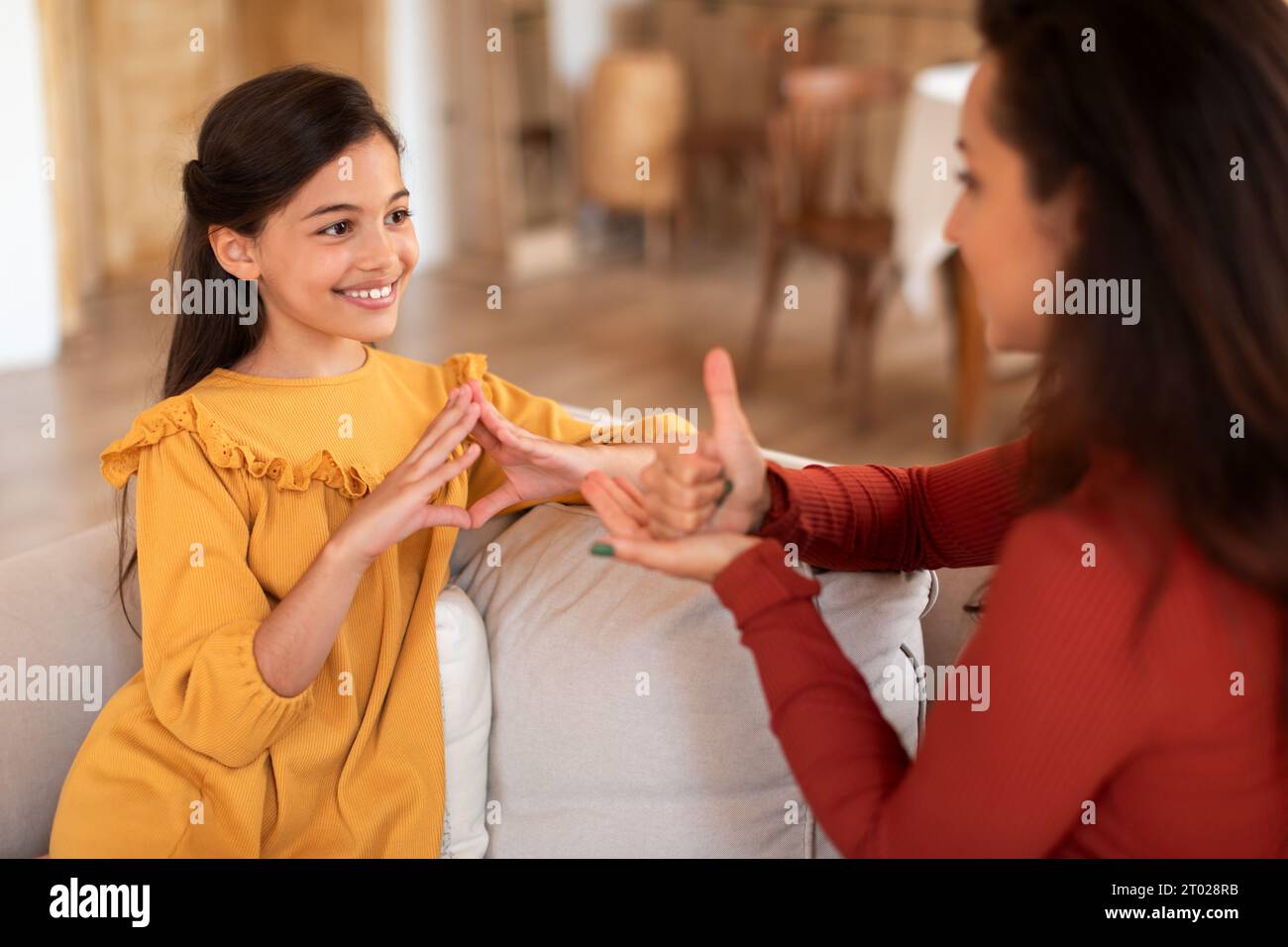 Girl Making Hand Gesture Using Sign Language With Tutor Indoor Stock ...