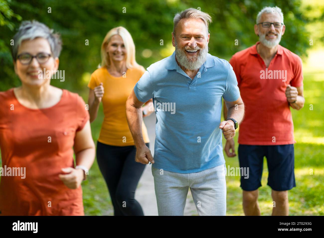 Active Retirement. Group Of Sporty Seniors Jogging Outdoors Stock Photo ...