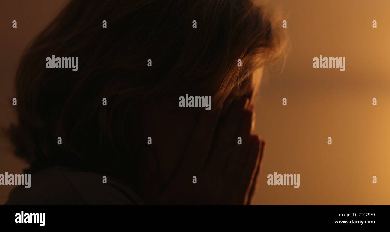 Anxious older woman suffering at night, close-up face. Troubled person ...