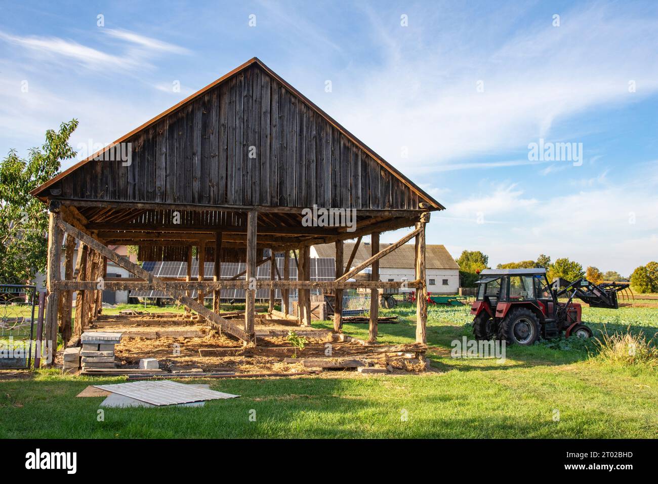 The skeleton of an old, destroyed barn being demolished on a sunny day ...