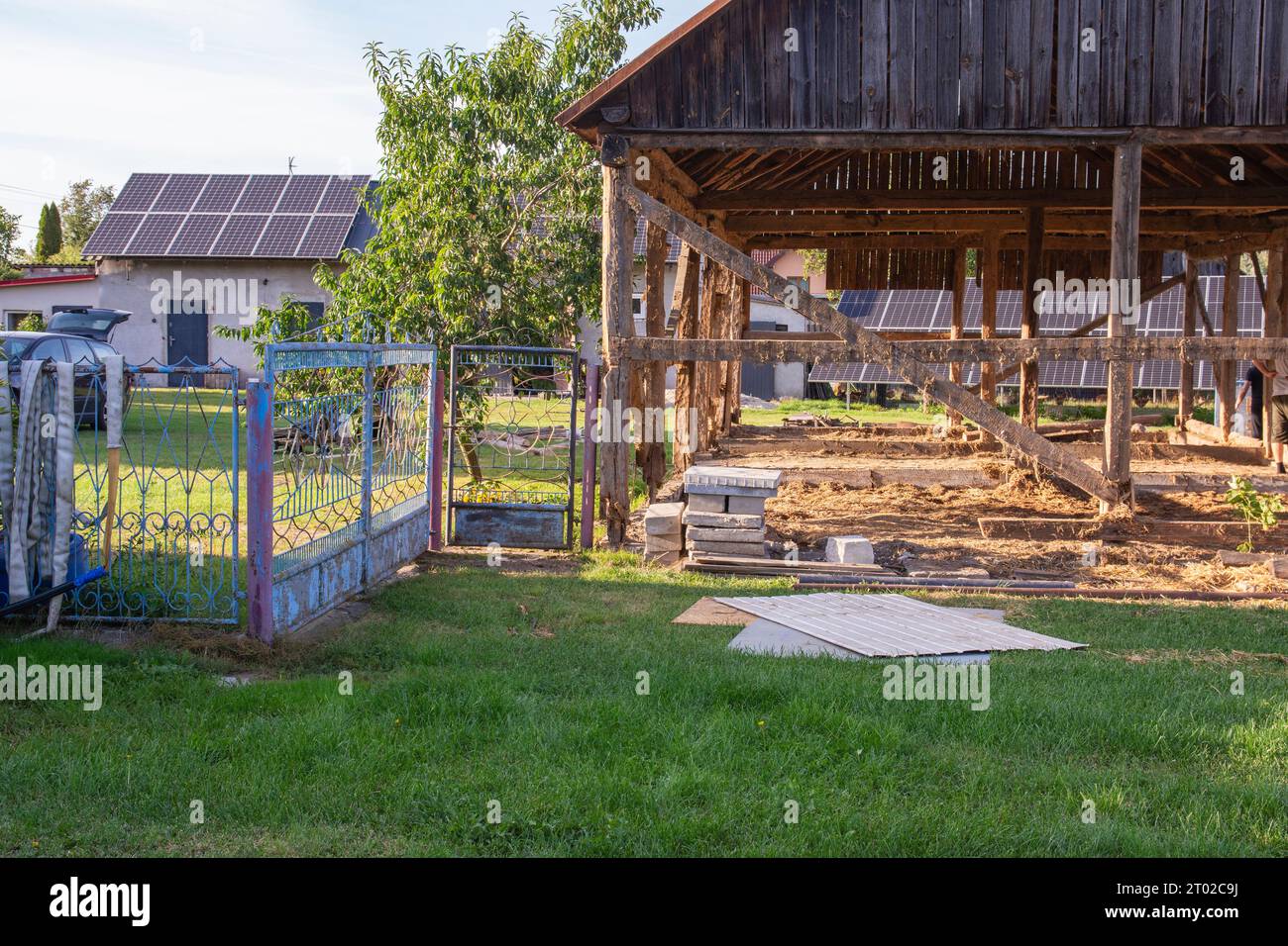 The skeleton of an old, destroyed barn being demolished on a sunny day ...