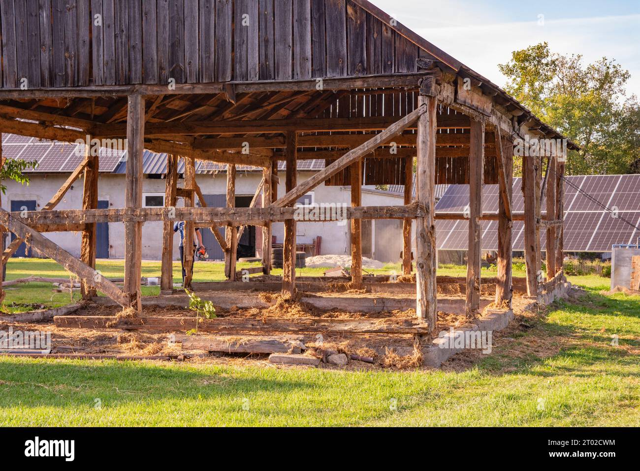 The skeleton of an old, destroyed barn being demolished on a sunny day ...