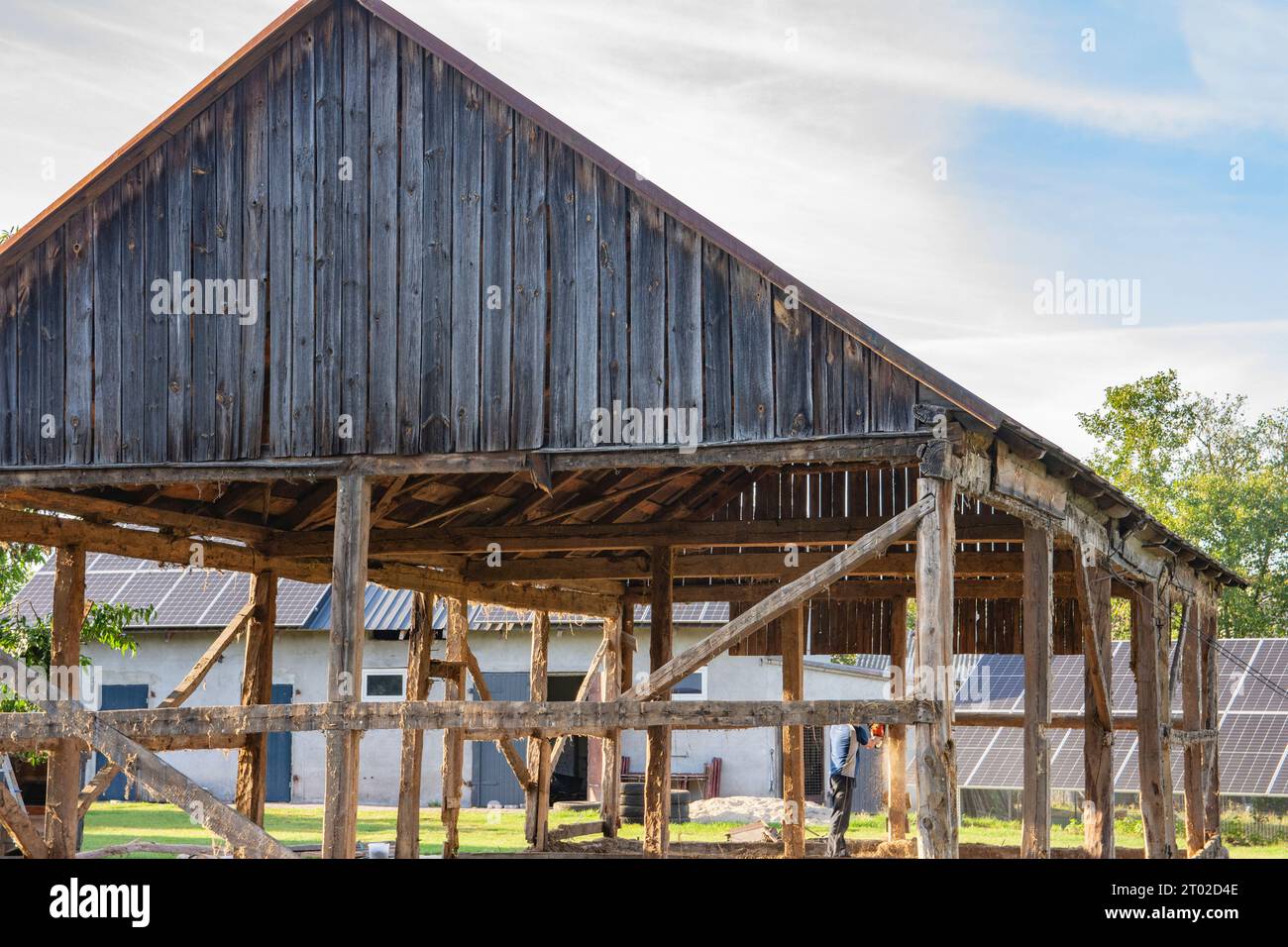 The skeleton of an old, destroyed barn being demolished on a sunny day ...