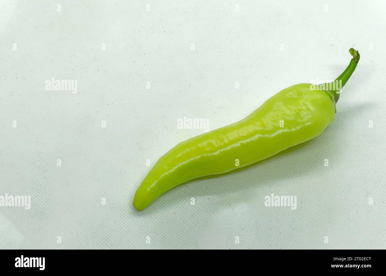 Food, isolated detail shot: yellow pointed peppers against a white ...