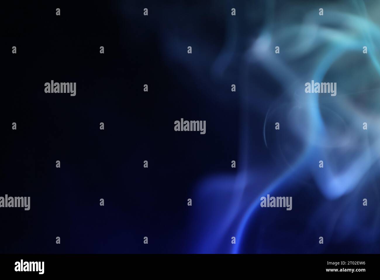 Blue fog, colored smoke on a dark background, abstract smoke shapes ...