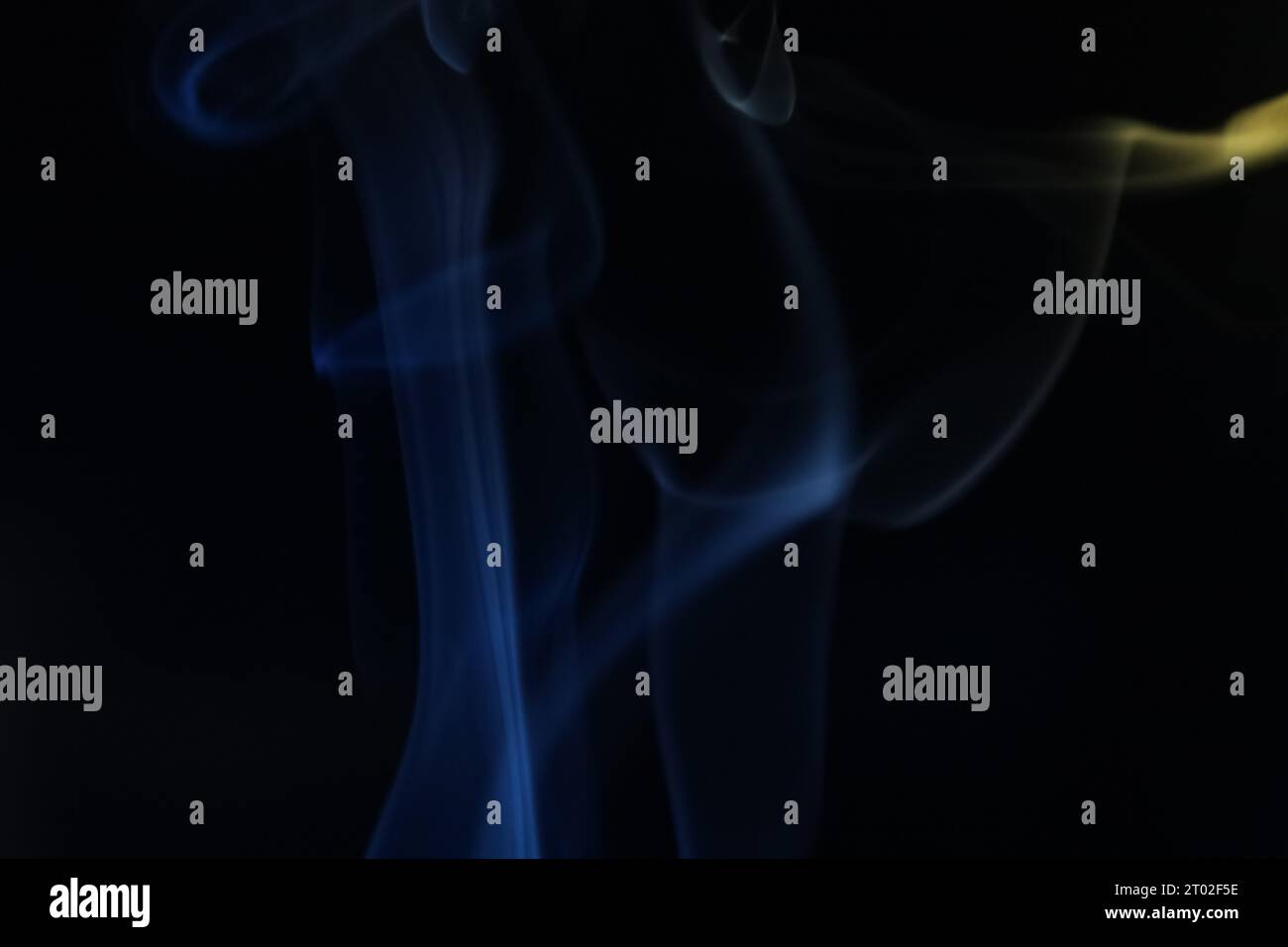 Yellow and blue smoke on a dark background, colourful abstract Stock ...