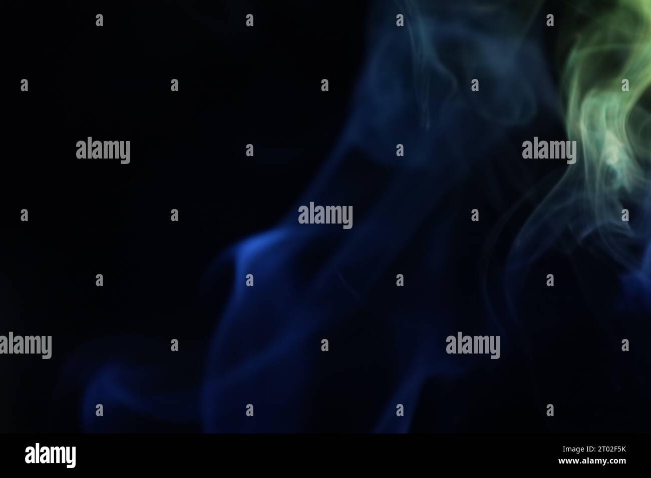 Yellow and blue smoke on a dark background, colourful abstract Stock ...