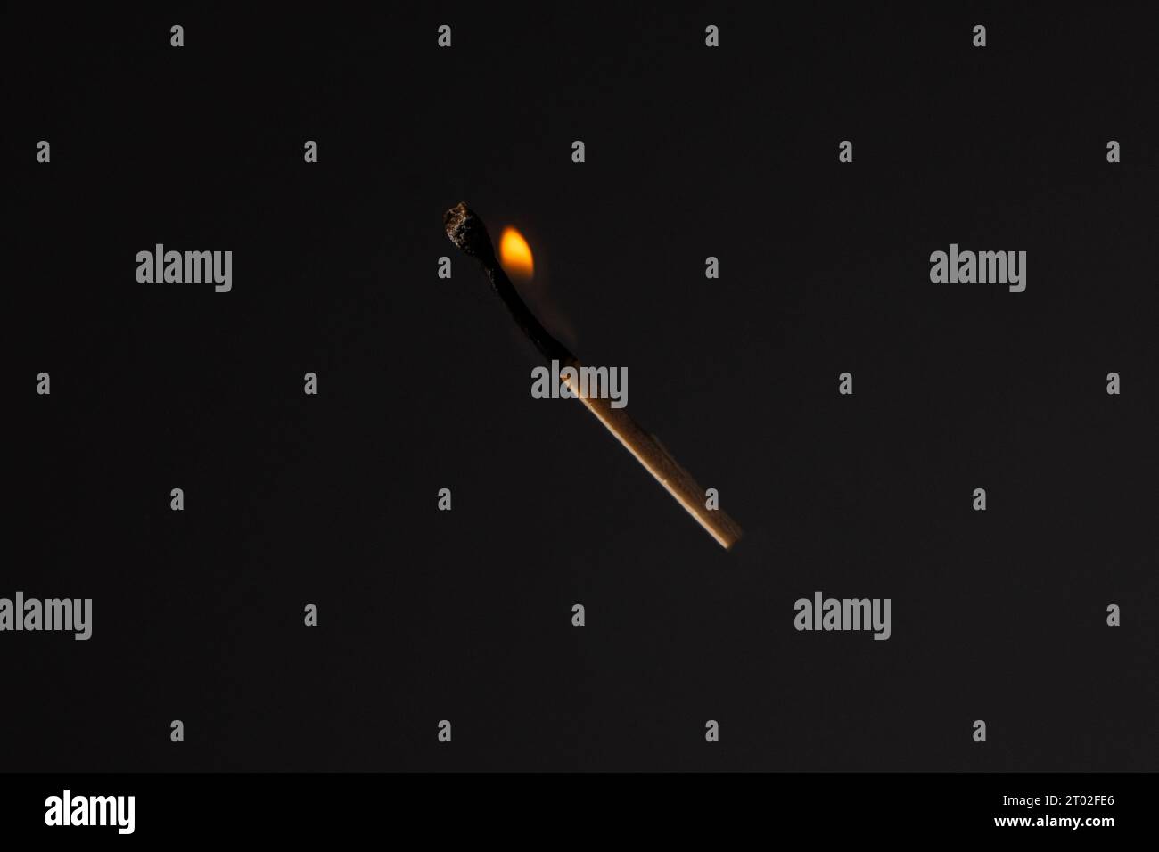Lit and falling match on a black background Stock Photo - Alamy