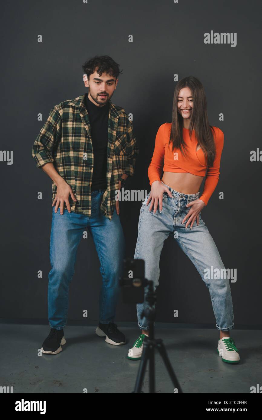 Young man and woman recording dance video tutorial for social media ...