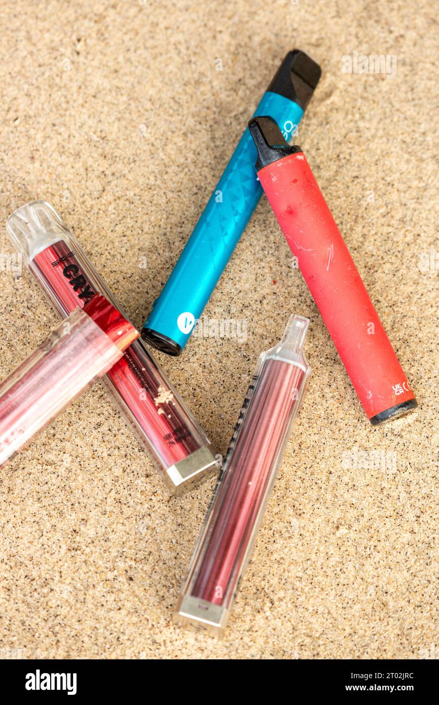 Single use disposable vapes lying discarded on a beach Stock Photo - Alamy