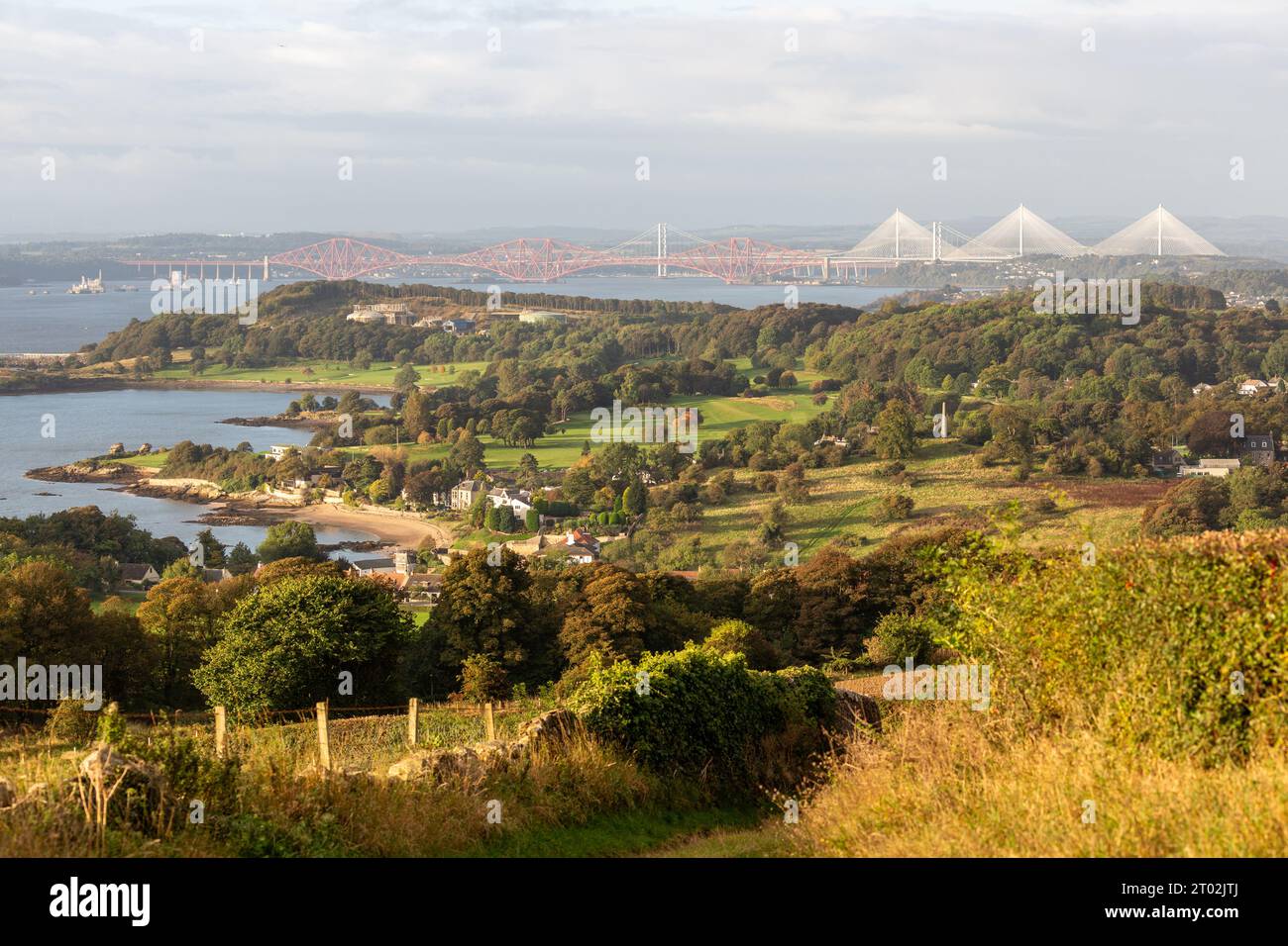 The picturesque village of Aberdour in Fife with the Forth Bridges in ...