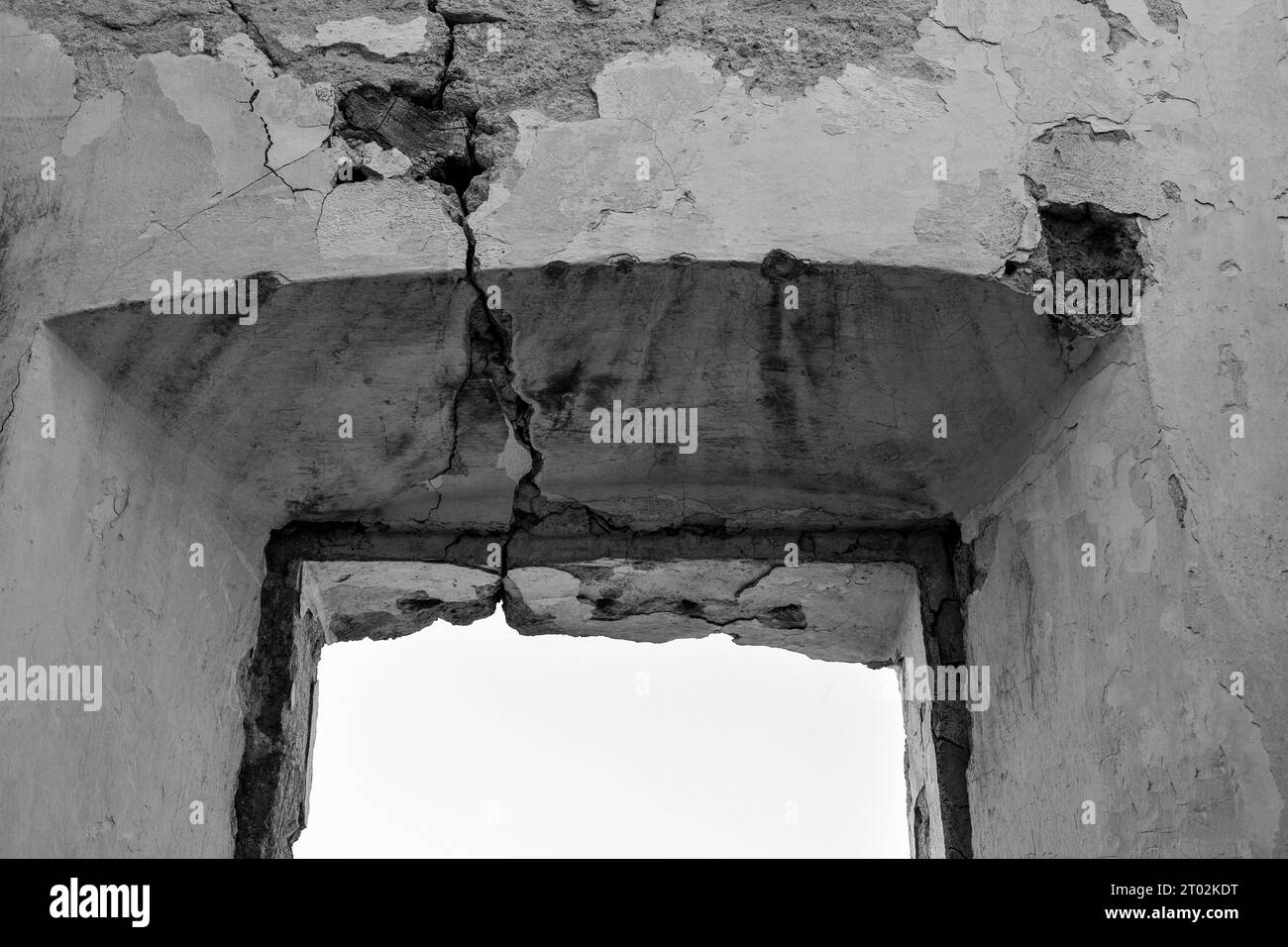 Half of a window opening in an old ruined building against the sky. The ...