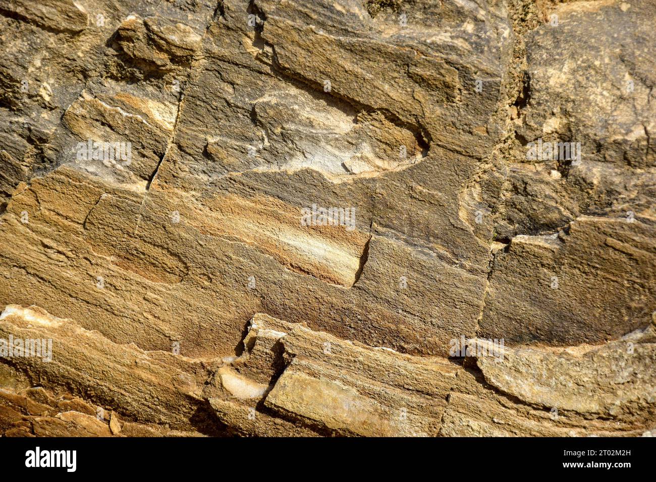 Background of coarse layered brown stone rocks, full frame. Rough stone ...