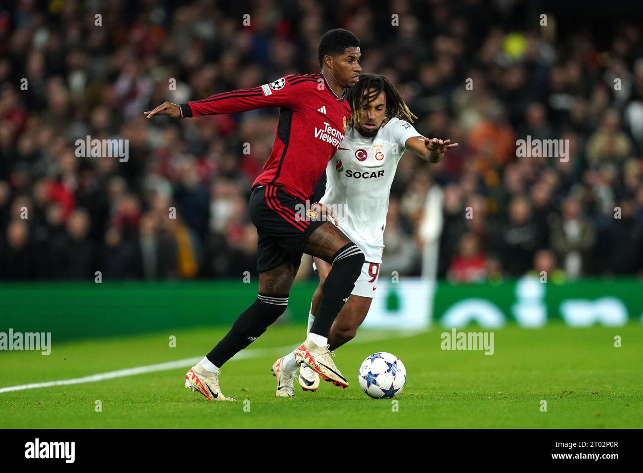 Manchester United's Marcus Rashford (left) and Galatasaray's Sacha Boey battle for the ball ...