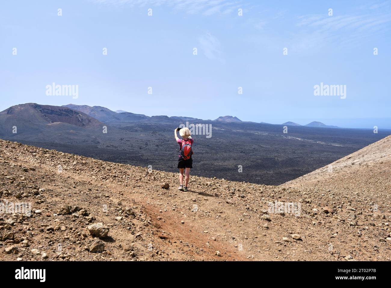 Woman hiker photographing volcanoes while hiking Stock Photo - Alamy