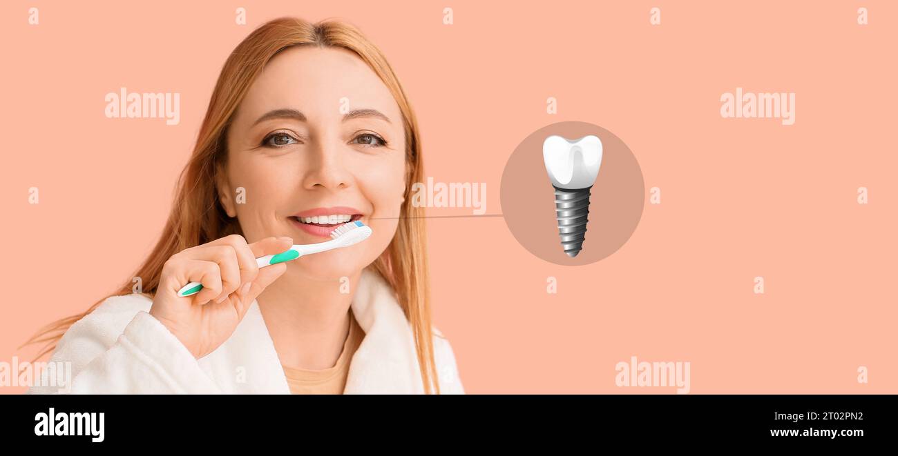 Mature woman with dental implant brushing teeth on color background ...