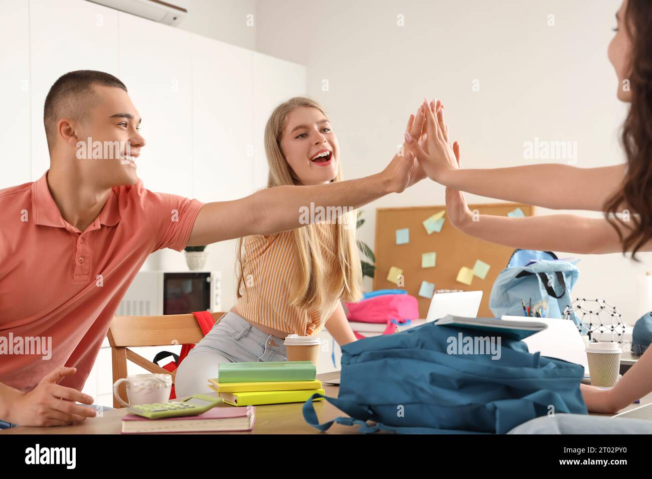 Students putting hands together in hi-res stock photography and images ...
