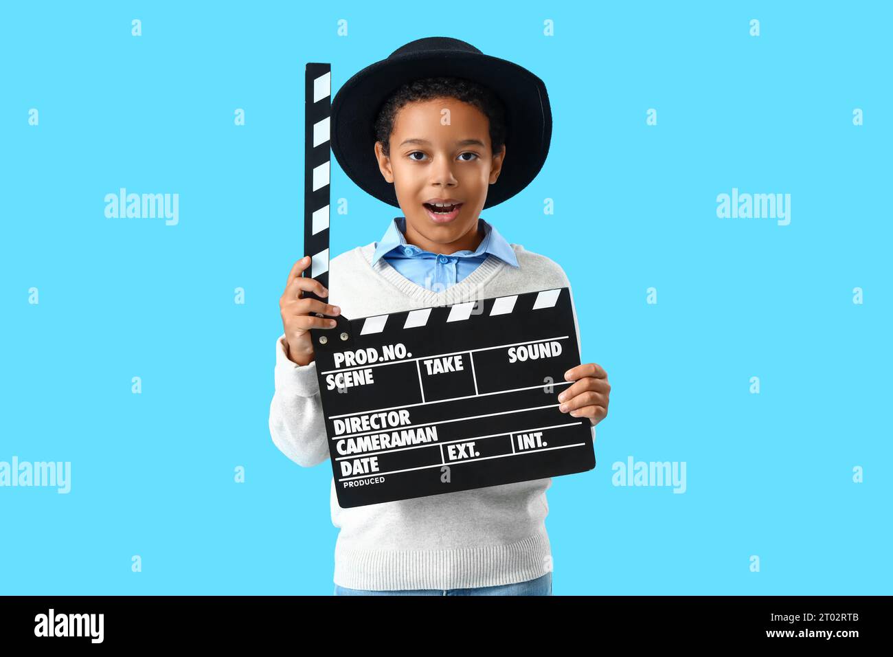 African-American little boy with movie clapper on blue background Stock ...