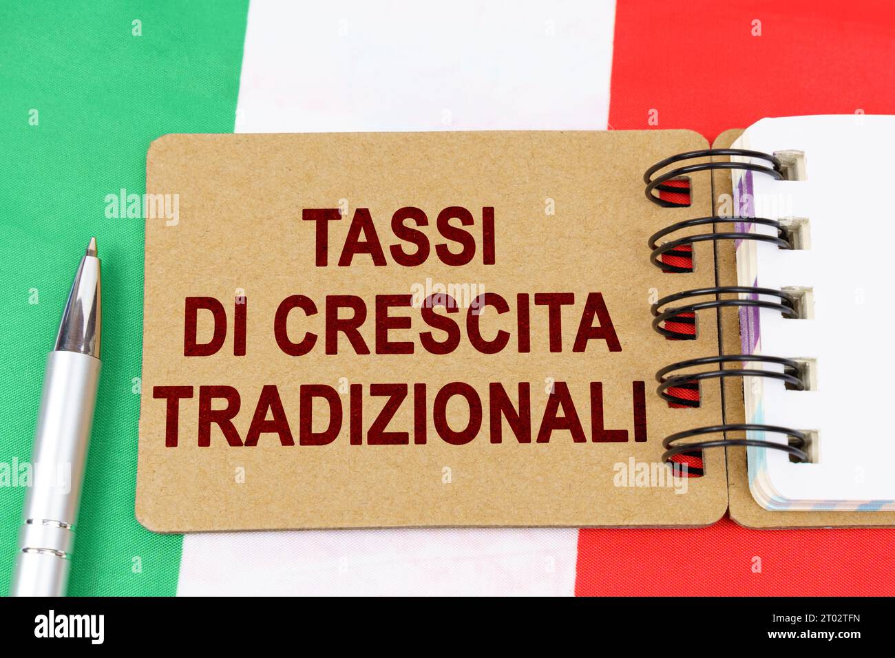 Economy and finance concept. On the flag of Italy lies a pen and a ...