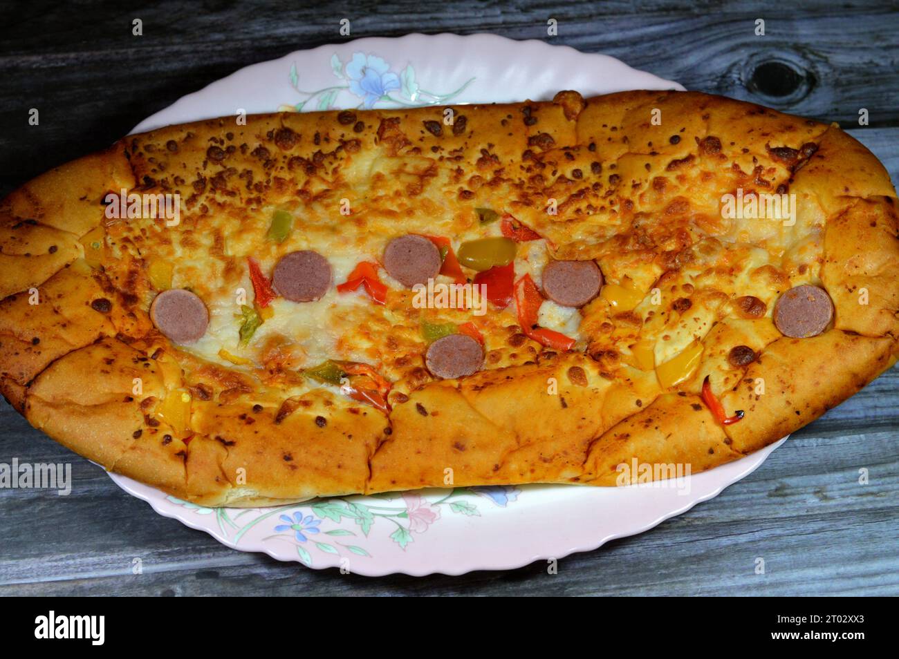 Cheese Fougasse topped with slices of green peppers, cheese, and cut ...