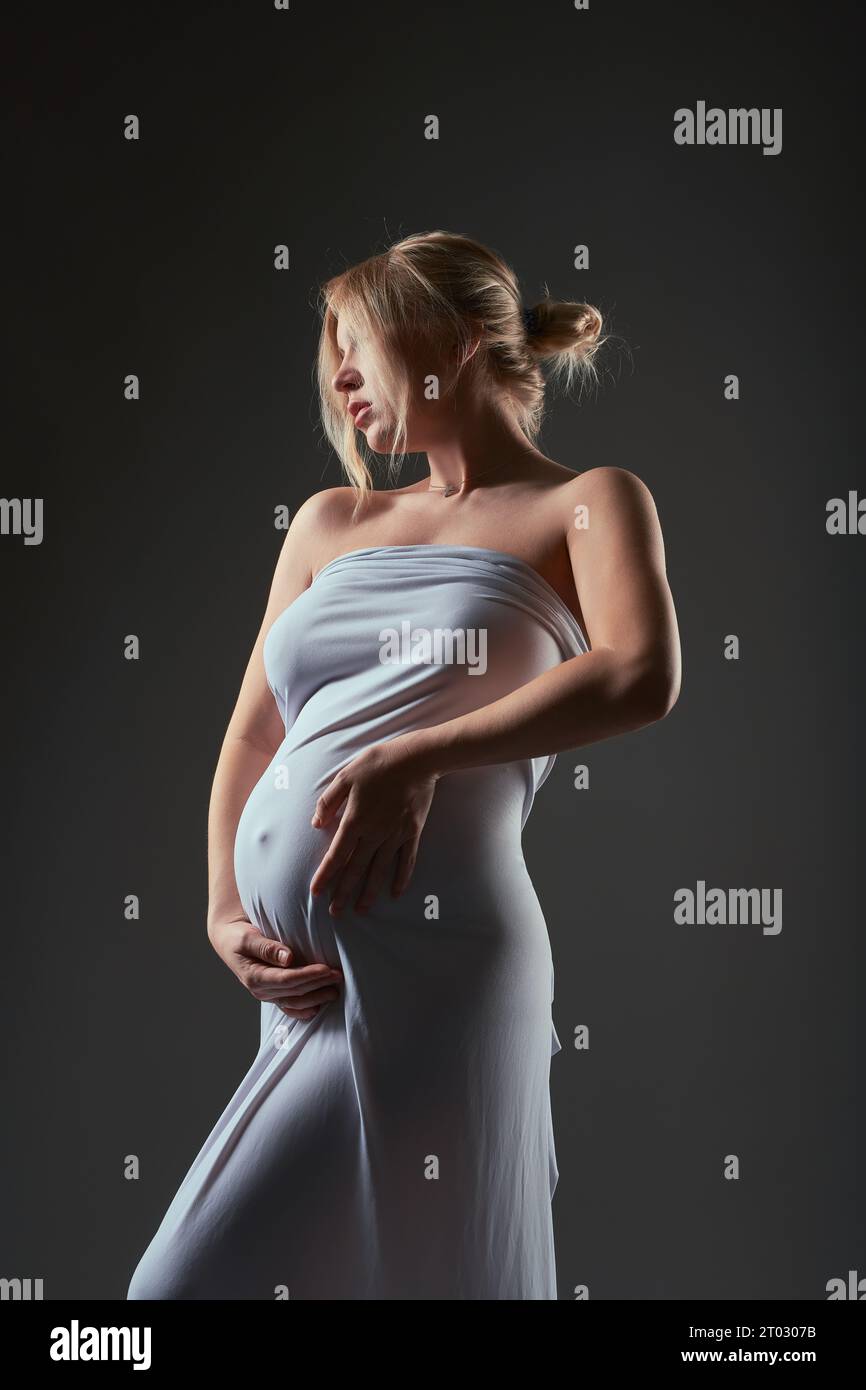 Beautiful pregnancy of young slim woman in silk Stock Photo - Alamy