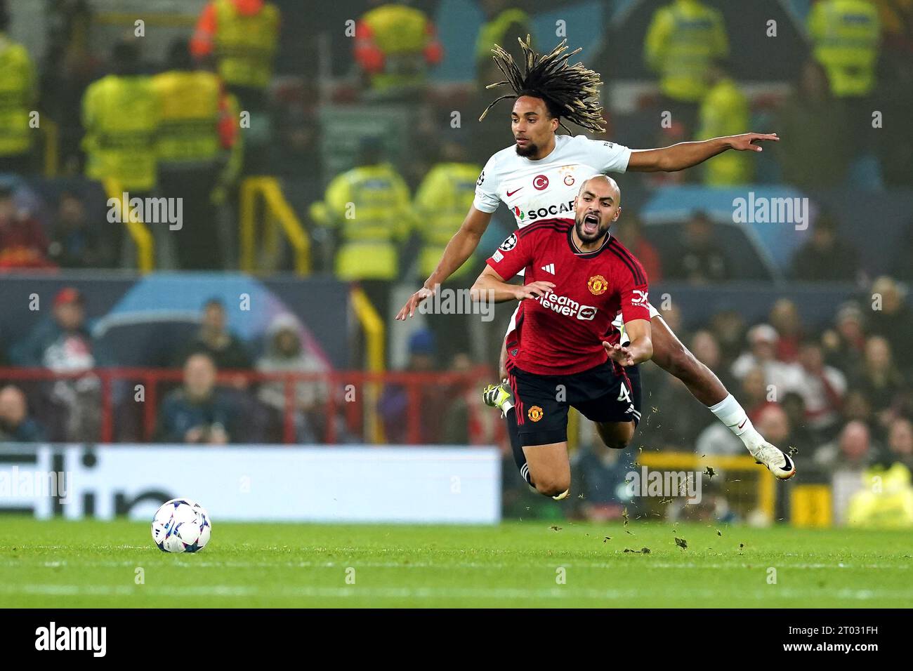 Manchester United's Sofyan Amrabat is tackled by Galatasaray's Sacha Boey (right) during the ...