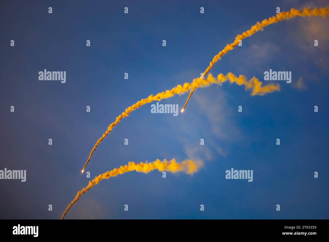 Beautifully glowing flares with a lot of smoke flying on the blue sky ...