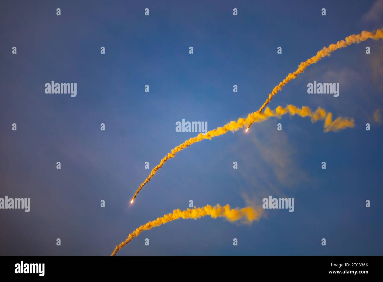 Beautifully glowing flares with a lot of smoke flying on the blue sky ...