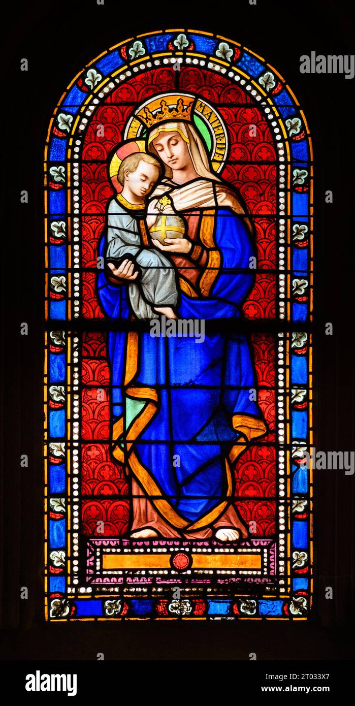 The Mother of God with Infant Jesus. A stained-glass window in Church ...