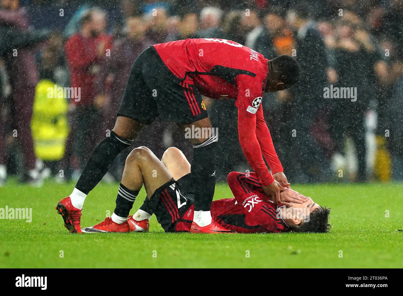 Manchester United's Alejandro Garnacho (right) is consoled by team-mate ...