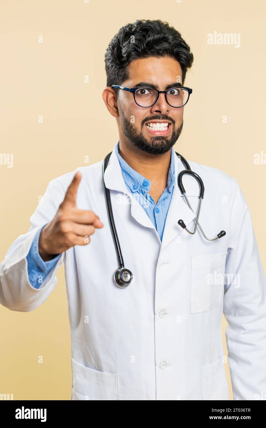Indian doctor cardiologist man shakes finger and saying no, be careful ...