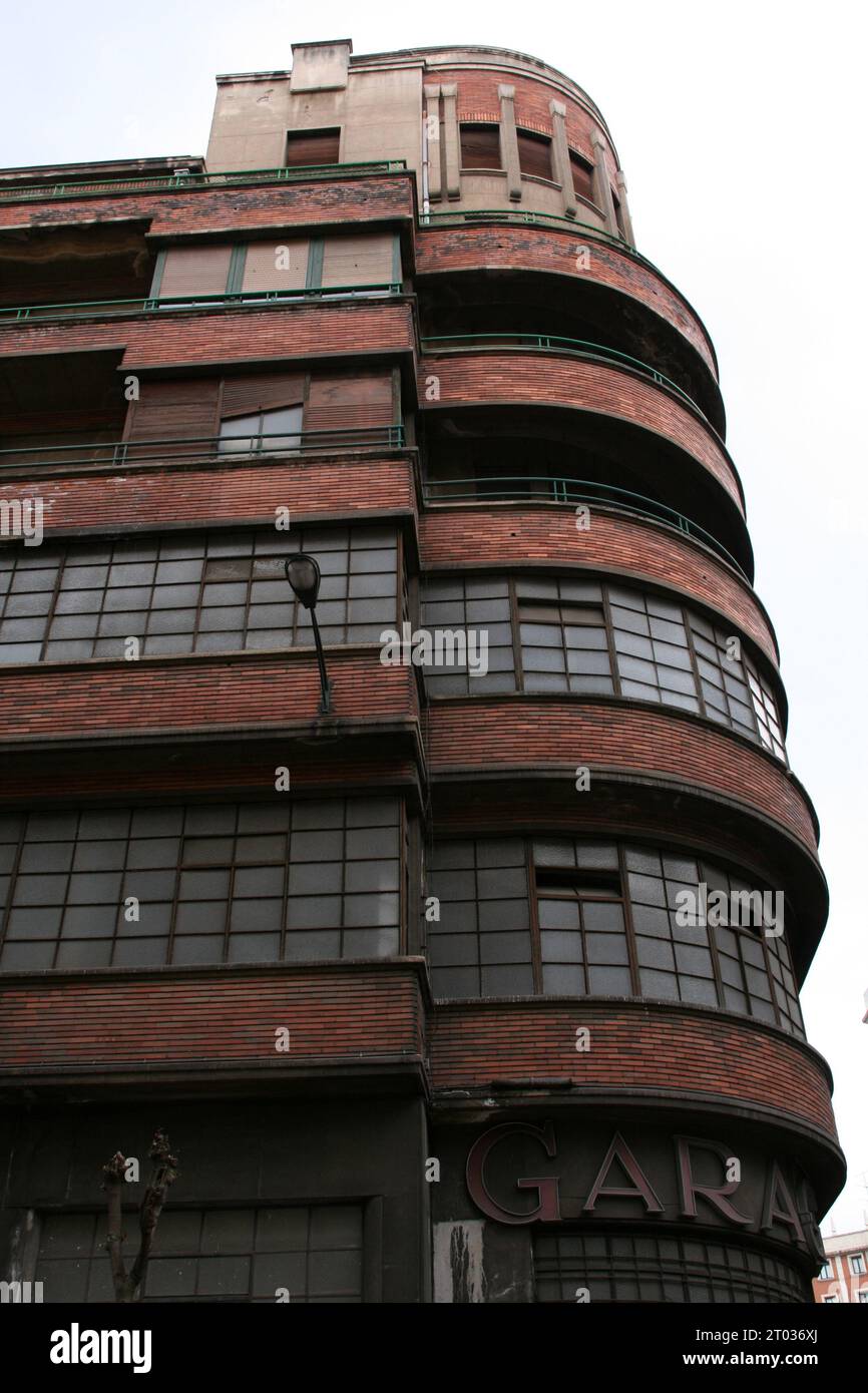 A vertical low angle shot of a rounded brick building in Bilbao, Spain ...