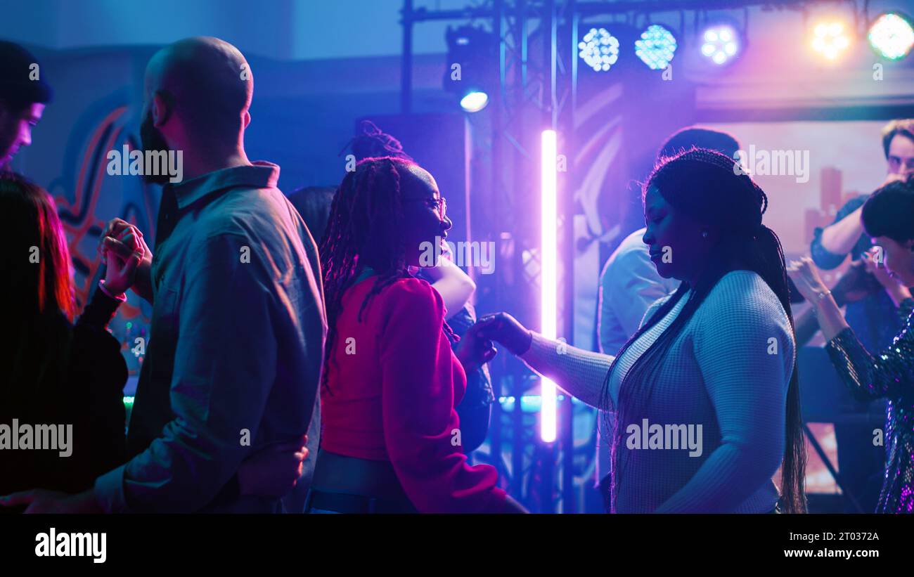 Young couples waltzing at nightclub, dancing in pairs on slow music on ...