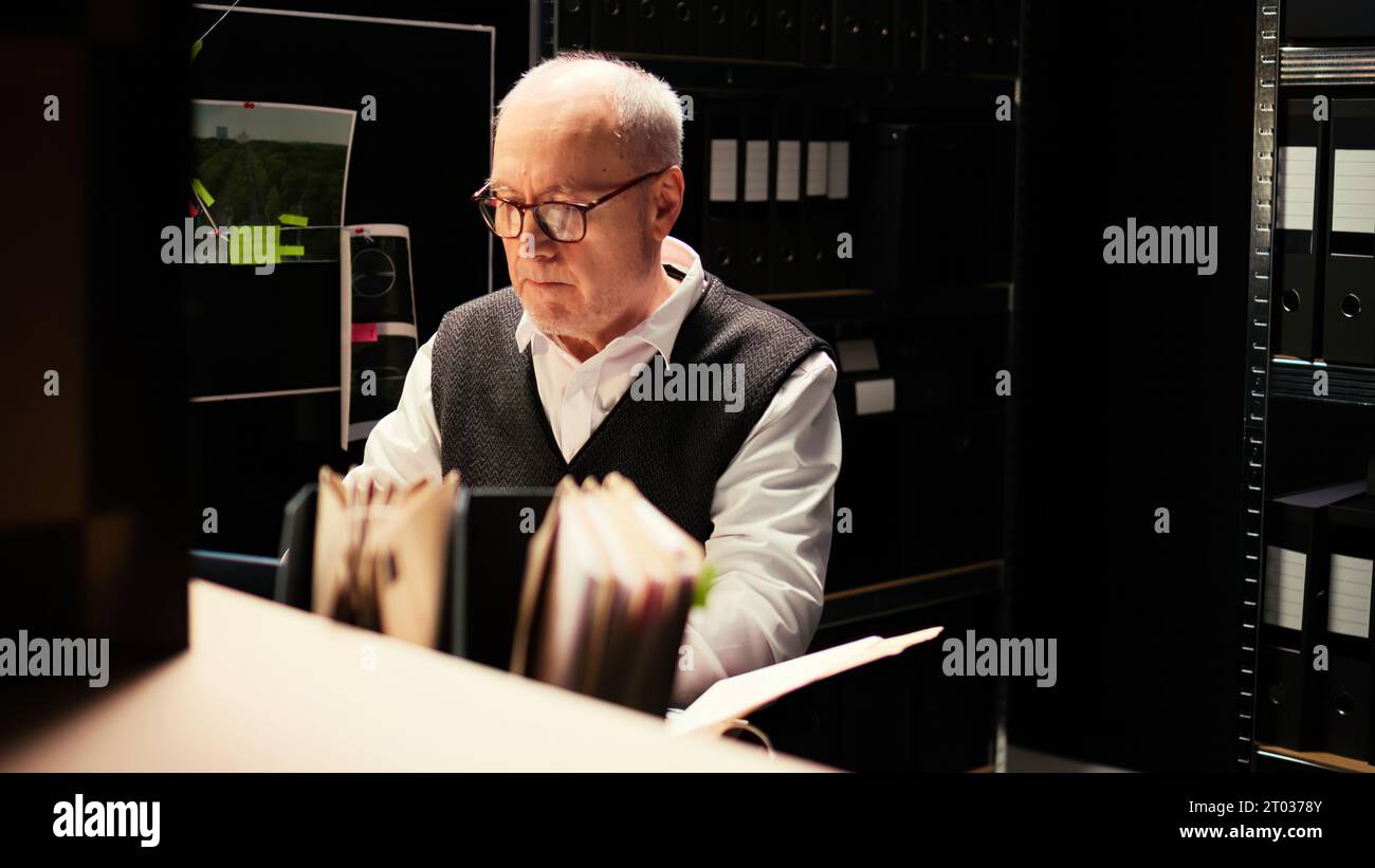 Private inspector review case files, reading confidential reports to ...