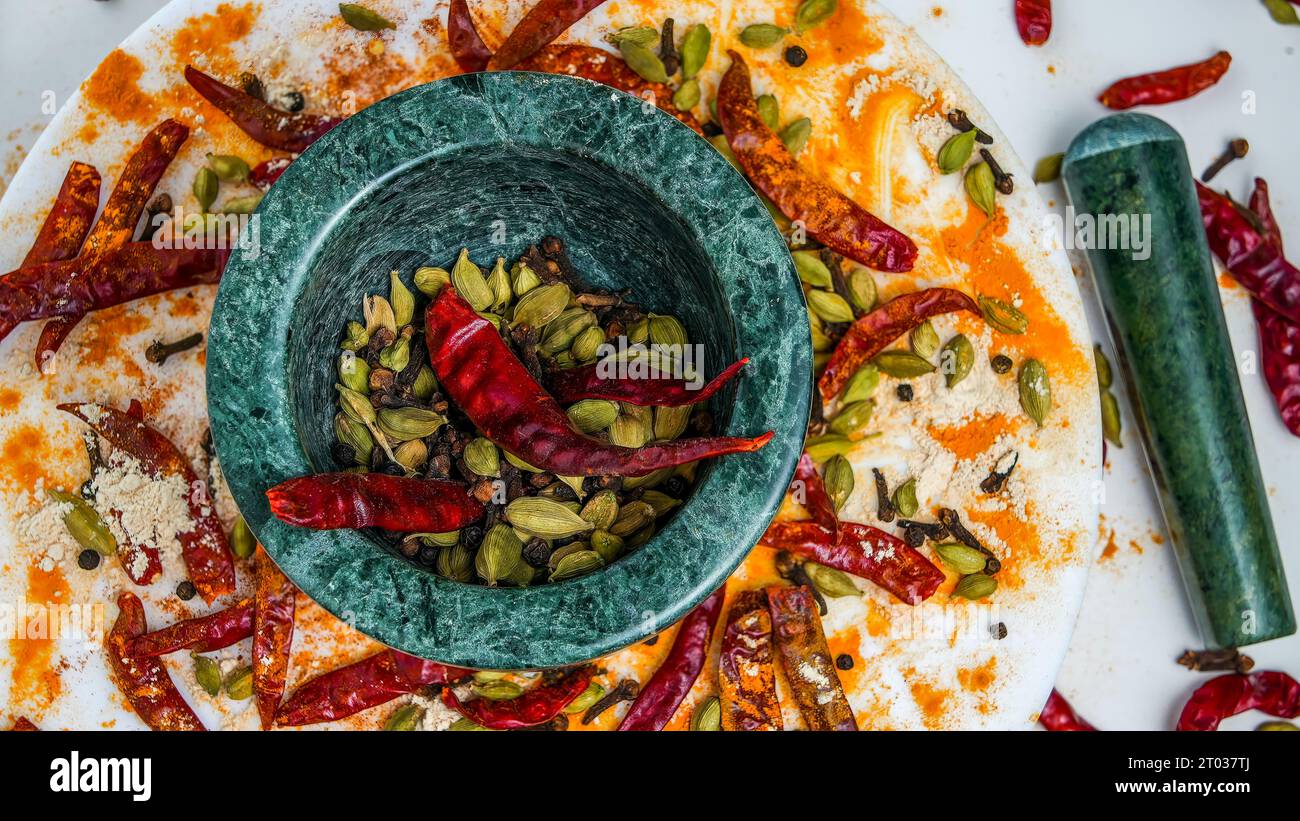 Granite mortar and pestle with spices from above Stock Photo - Alamy