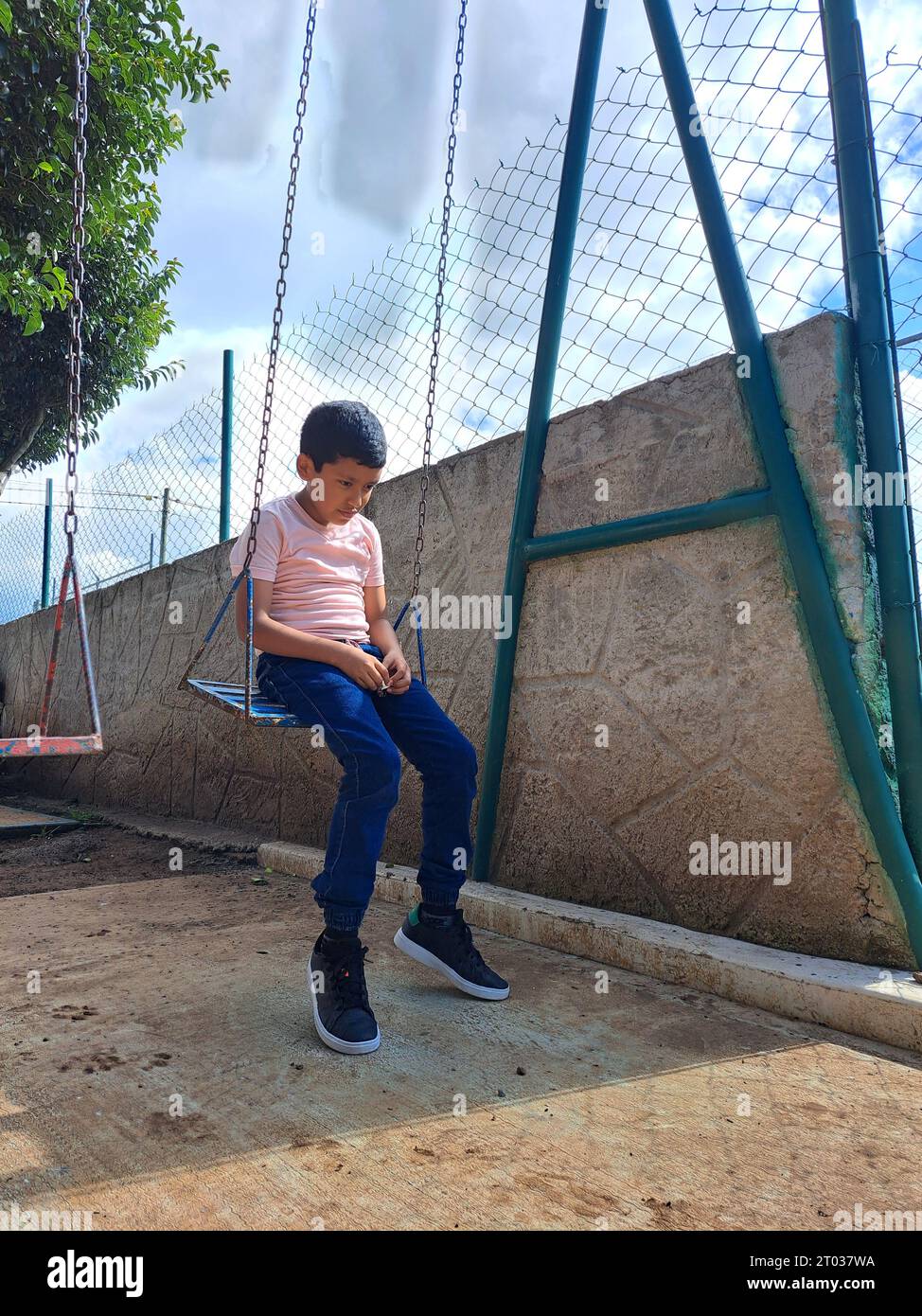 9-year-old dark-skinned Latin boy is sad in the games, suffers from his ...