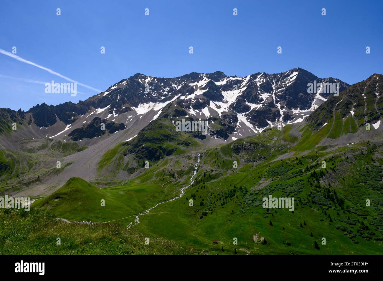 Mountains and green alpine meadows views near Col du Lautaret, Massif ...