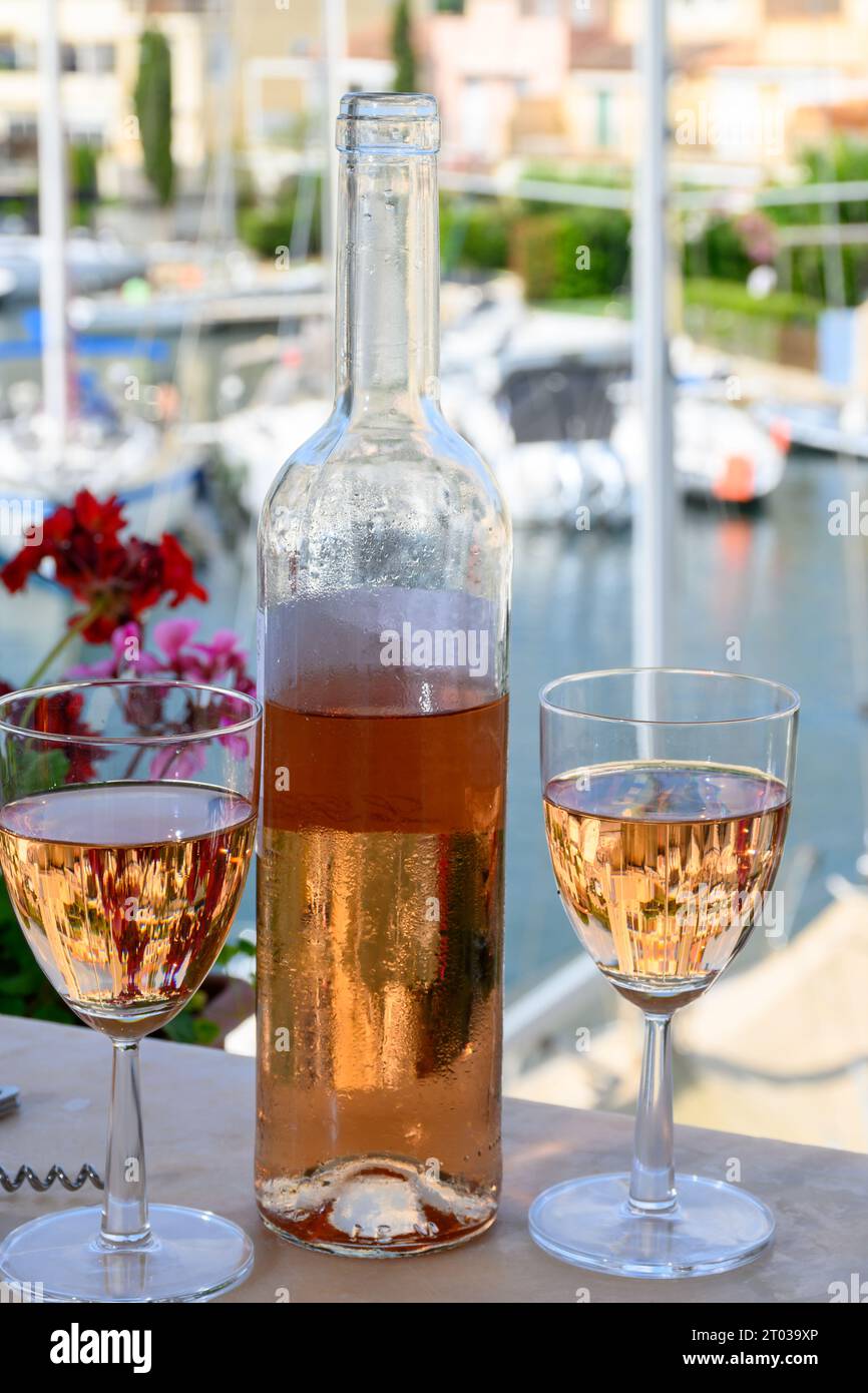 Glasses of cold rose Cote de Provence wine in yacht harbour of Port ...