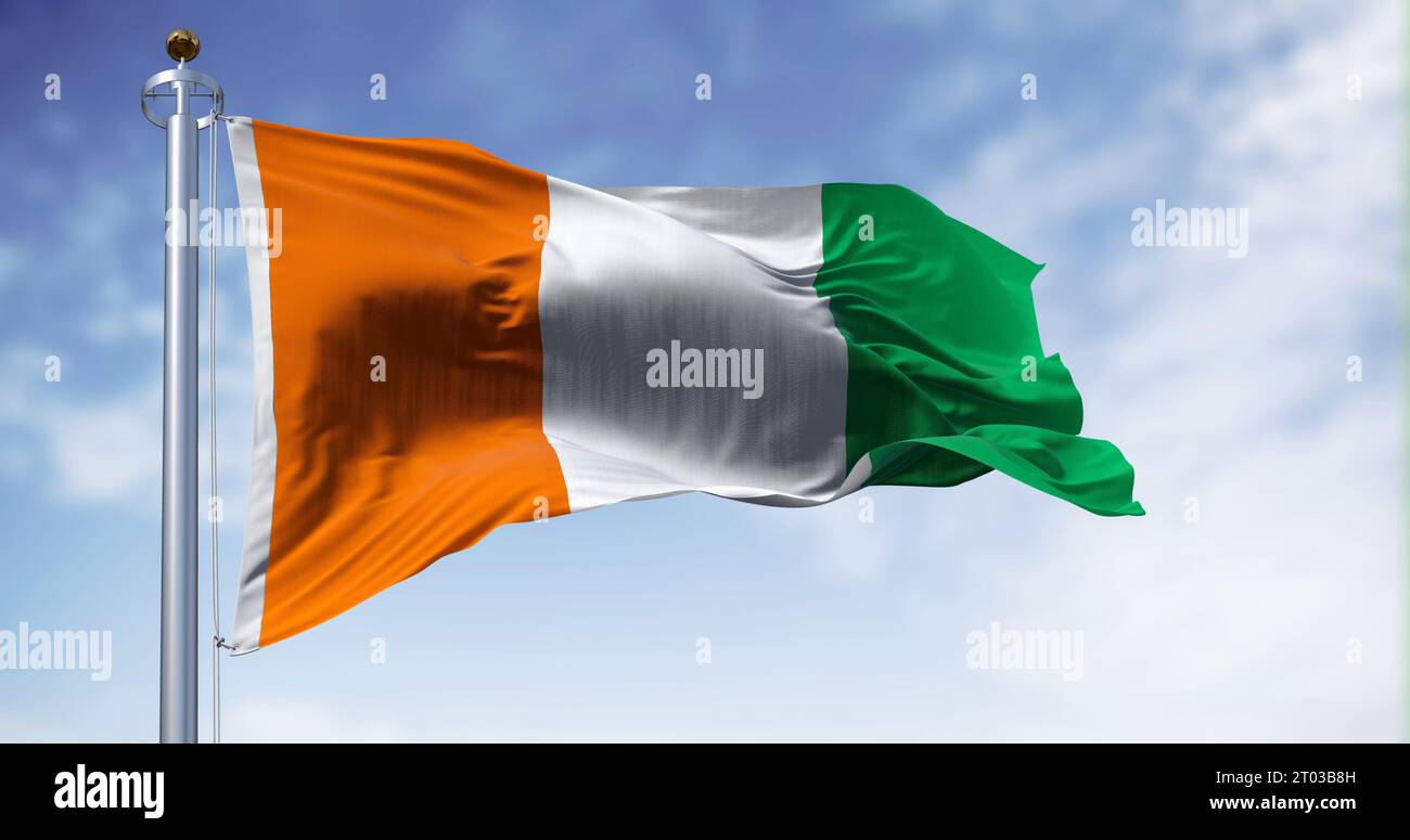 Ivory Coast national flag waving in the wind on a clear day. Three ...