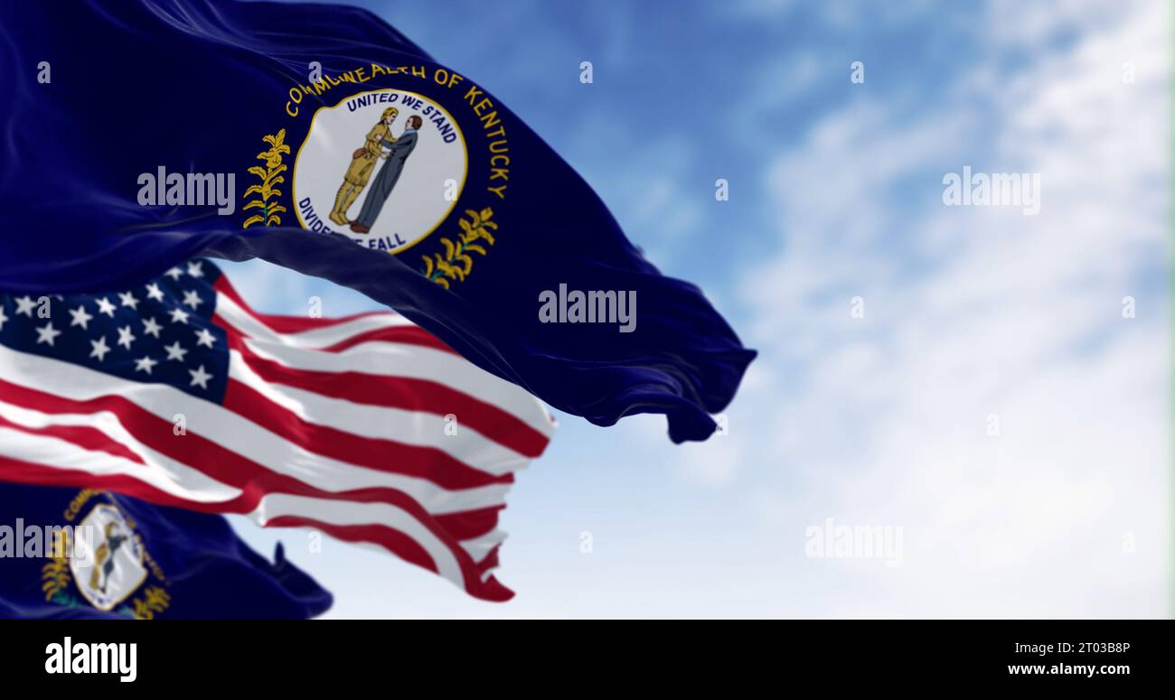 Kentucky state flag and the American flag waving in the wind on a clear ...