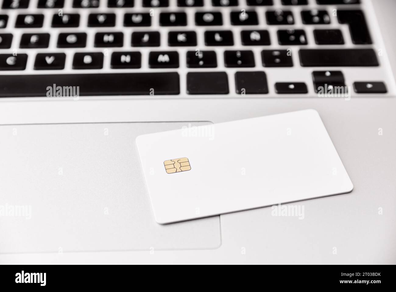 Blank white credit or debit card with microchip on a laptop. Concepts ...