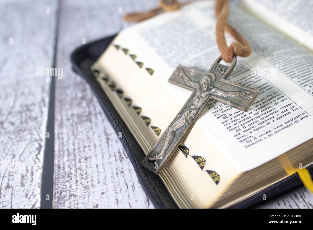 Wooden cross on top of an open bible and wood table. Copy space Stock ...