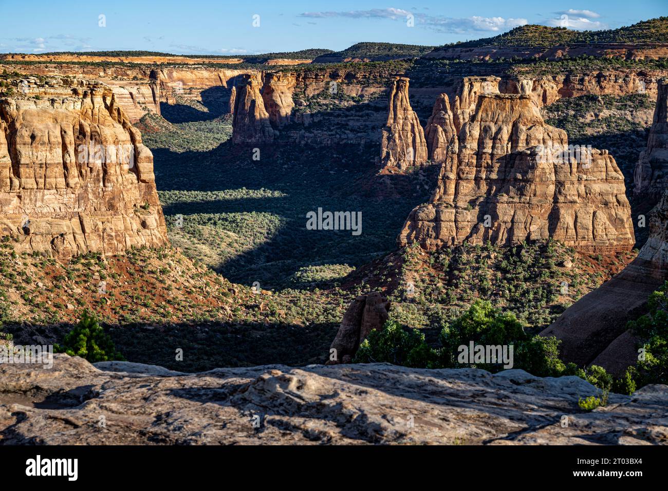 Dusk light illuminates the monumnets in Monument Canyon in Colorado ...