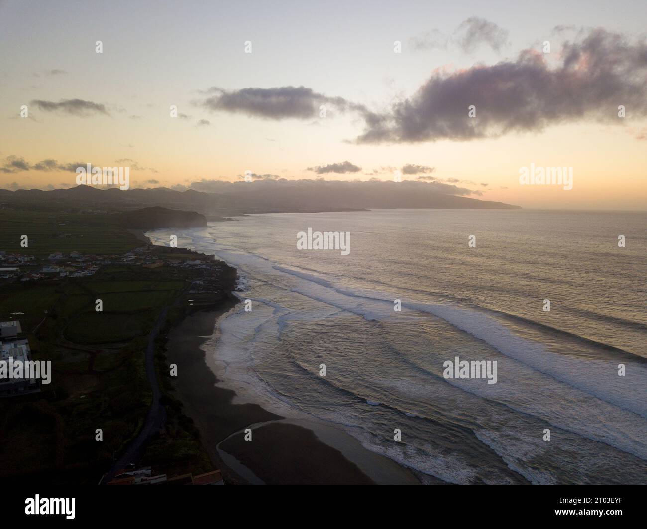 Aerial view of sunset over the sea with the shore of Ribeira Grande and ...