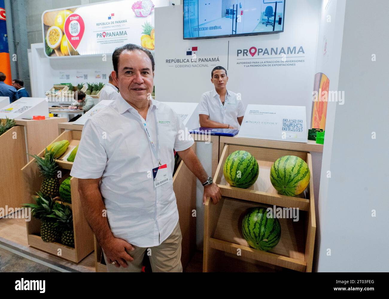 A man poses in front of a stall during the International Fruit and ...