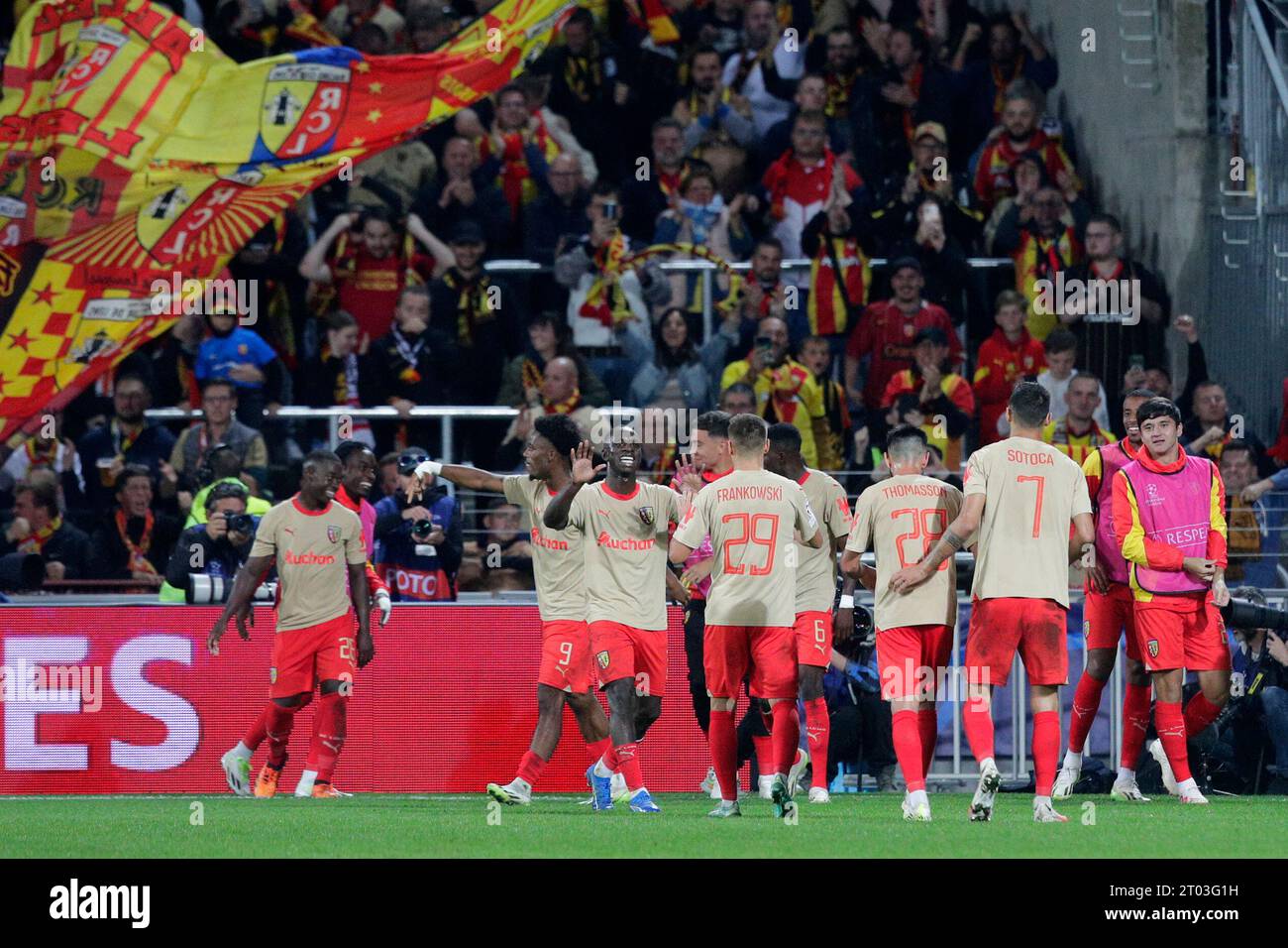 Lens' players react after scoring during the Group B Champions League ...