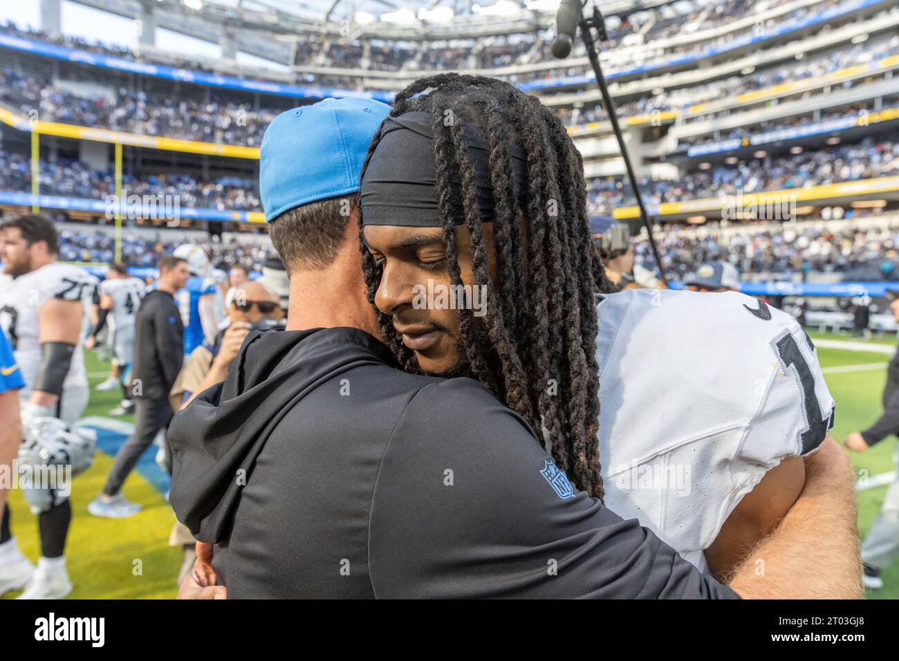 Las Vegas Raiders Davante Adams (17) hugs Los Angeles Chargers head ...