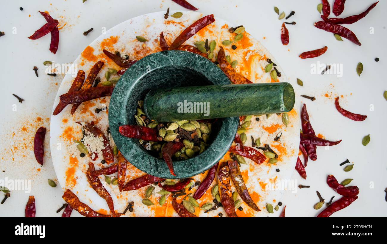 Granite mortar and pestle with spices from above Stock Photo - Alamy