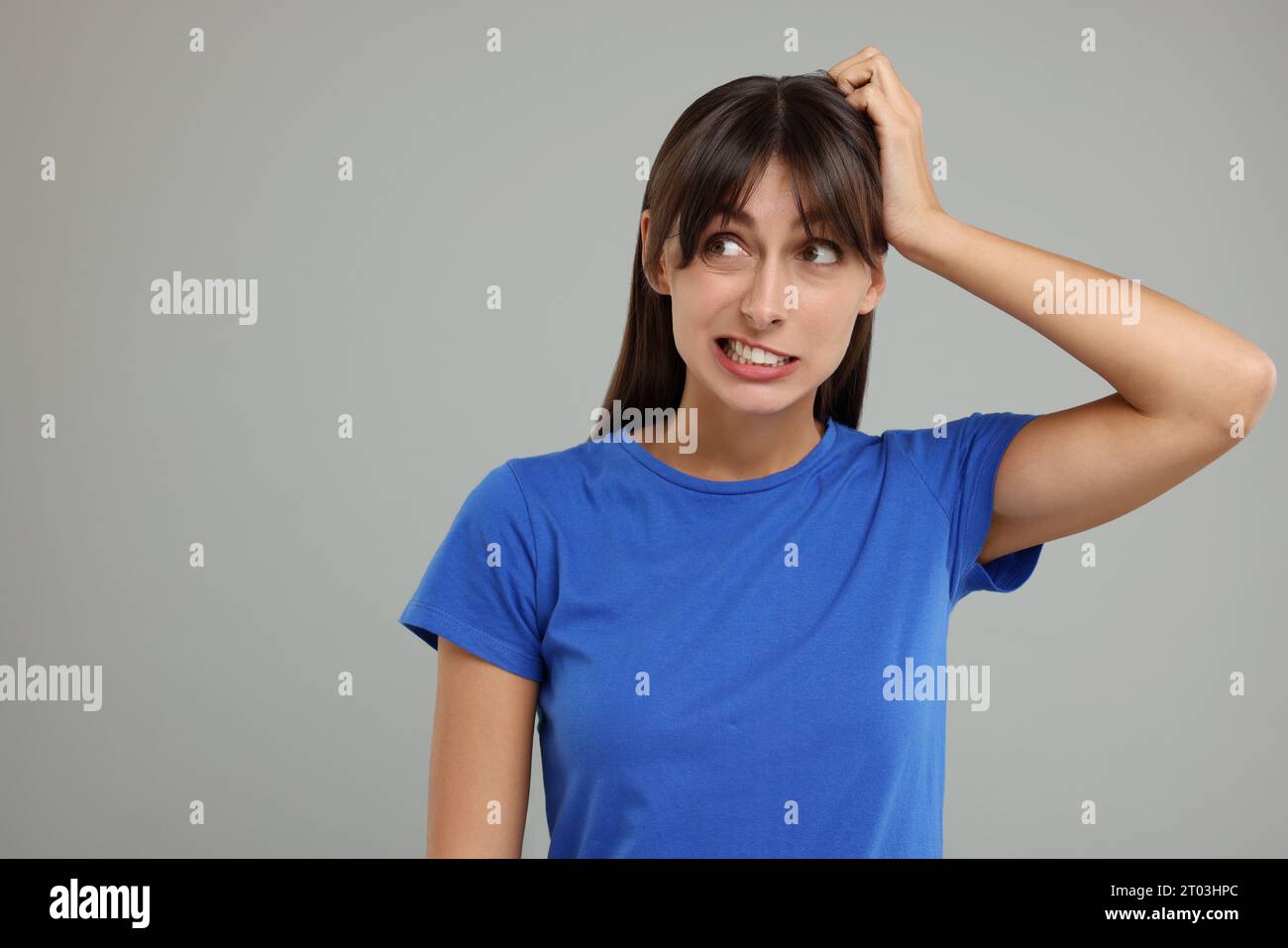 Embarrassed woman on light grey background, space for text Stock Photo ...